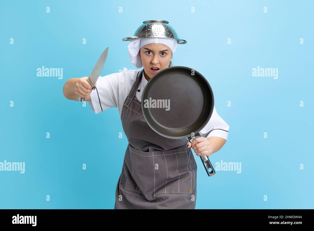 Kitchen knight. Comic portrait of pretty man, cook, female chef in ...