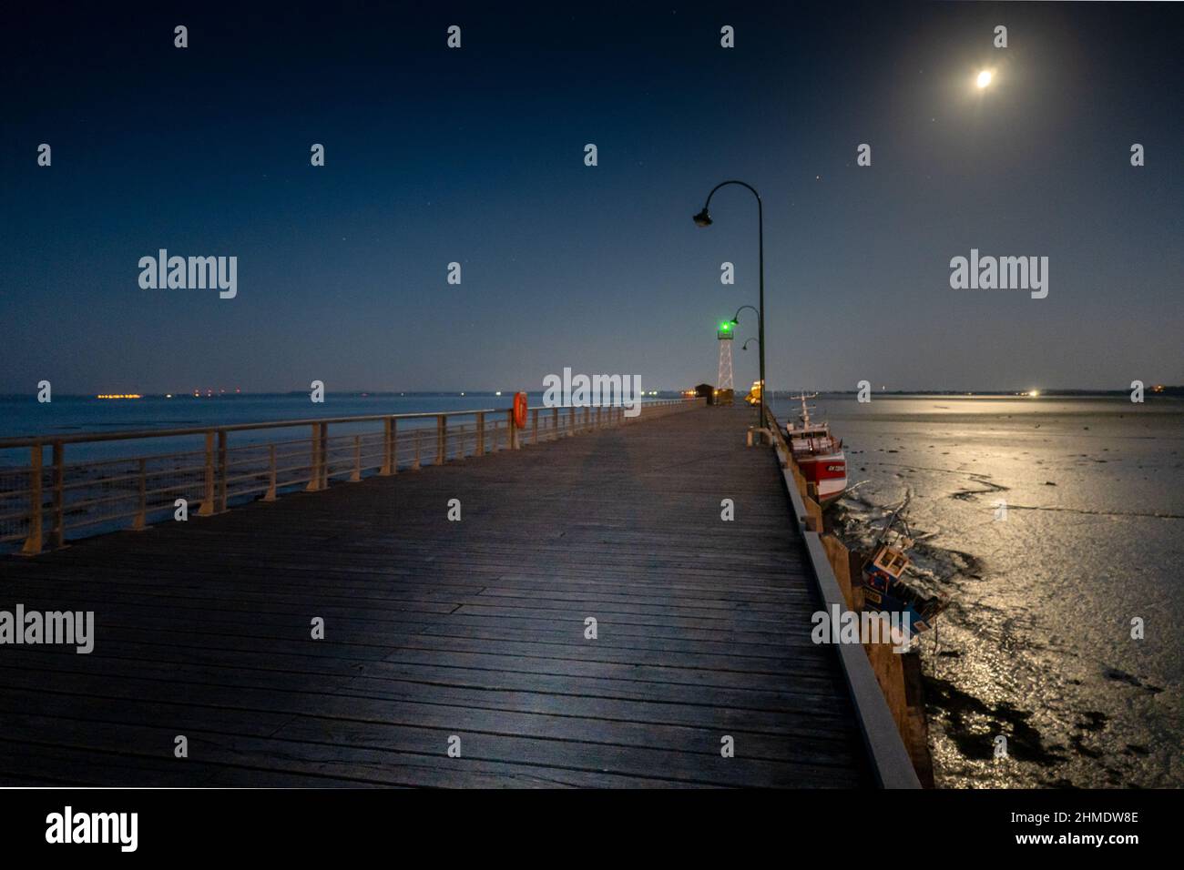 Scenic view of jetty towards sea at night, Brittany, France Stock Photo ...
