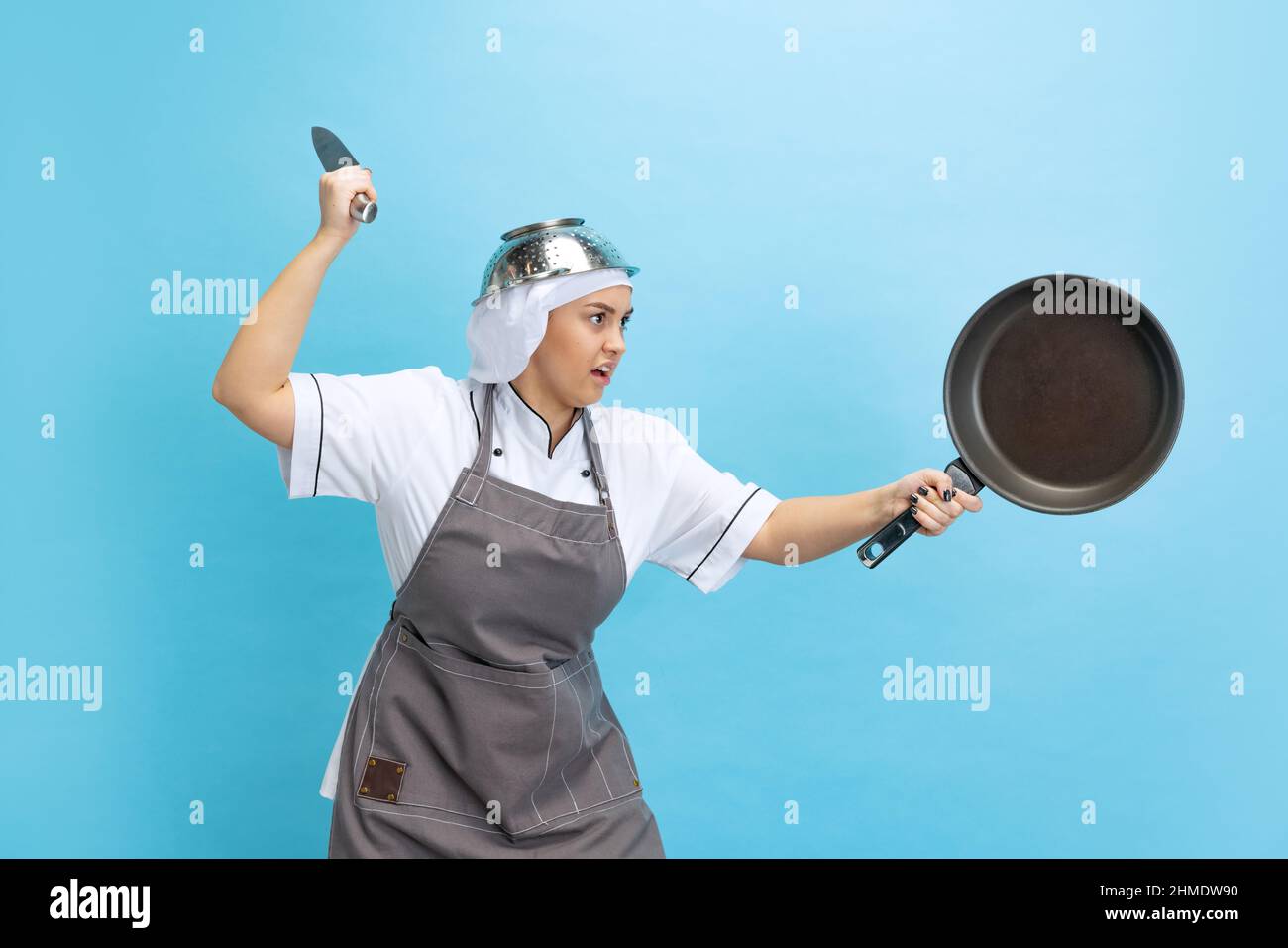 Kitchen knight. Comic portrait of pretty man, cook, female chef in ...