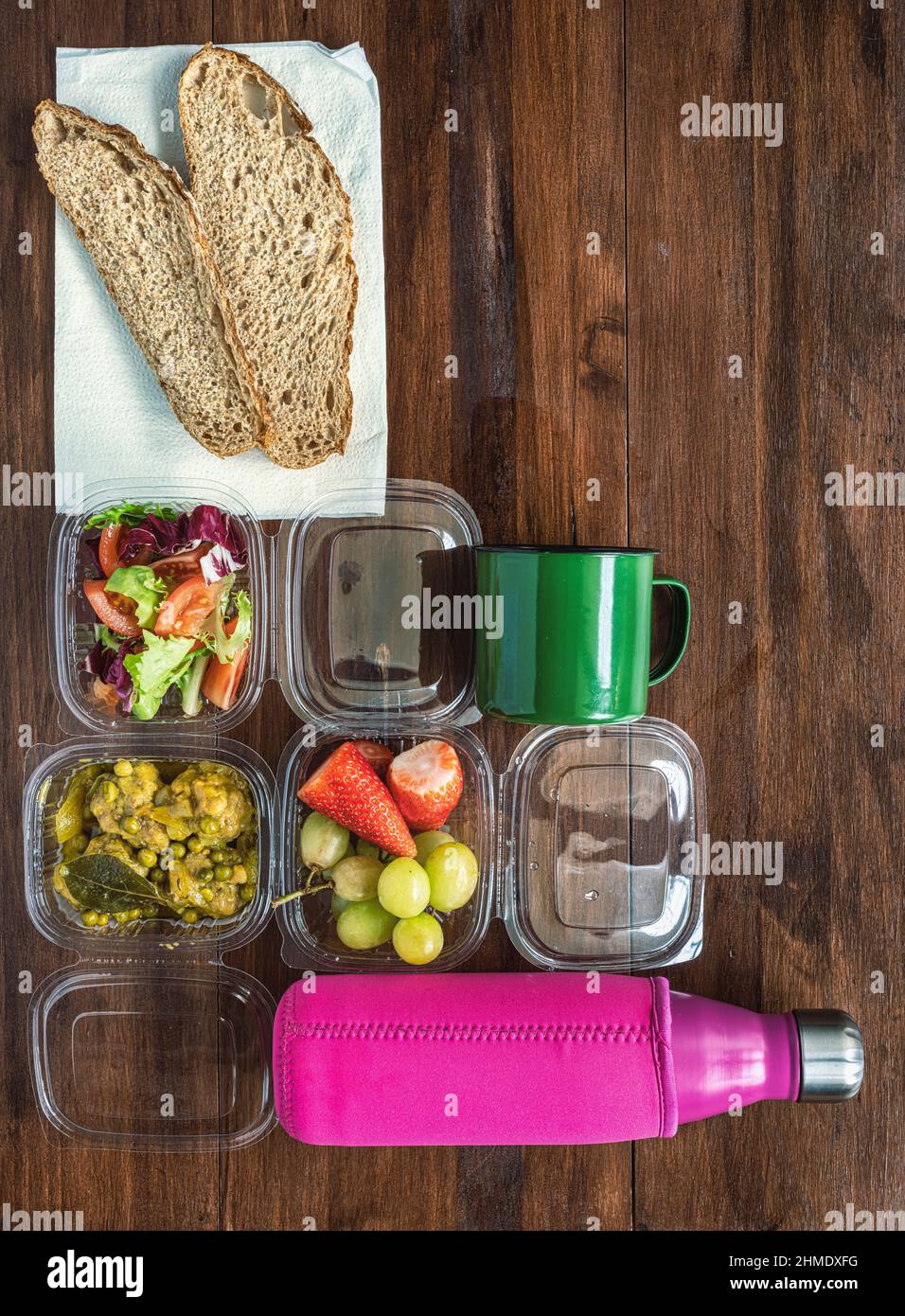 Meals prepared at home and packed in boxes to take away: salad with ...