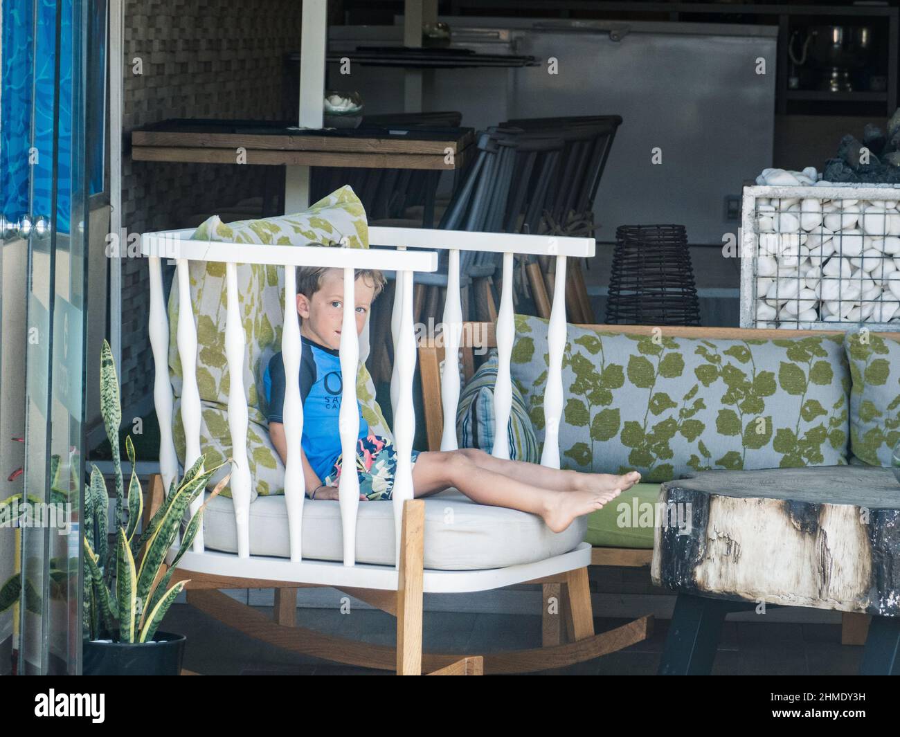 Cute boy sitting on wooden rocking chair at home Stock Photo - Alamy