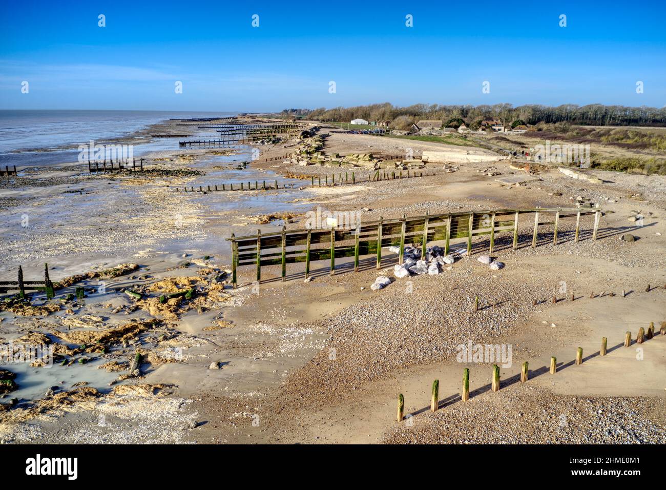 An old isolated wooden groyne and sea defence on a beach in Southern ...