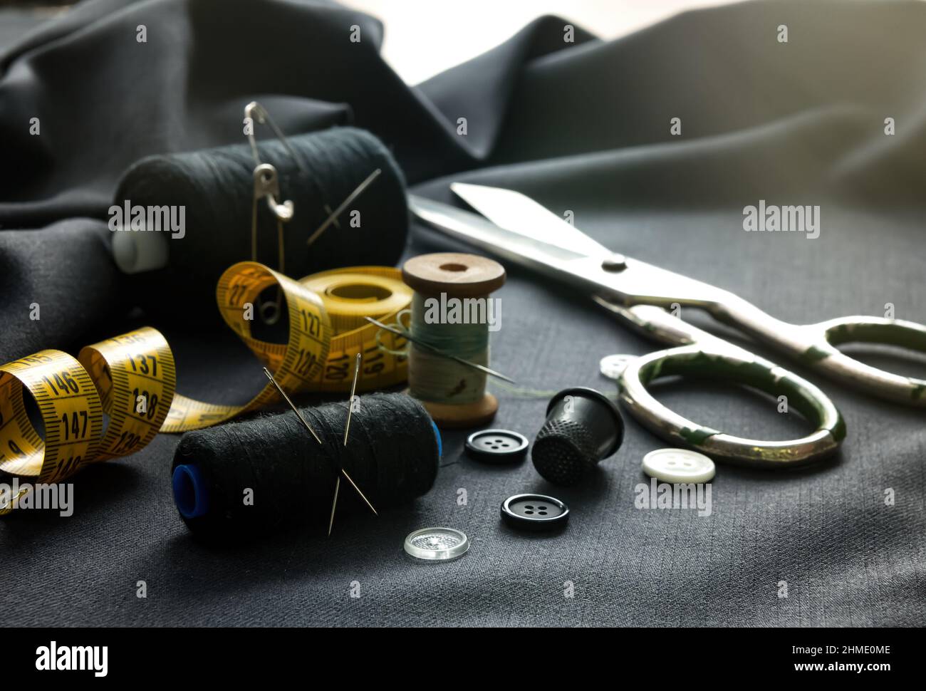 Retro tools for cutting and sewing. Needle with thread, thimble, sewing ...