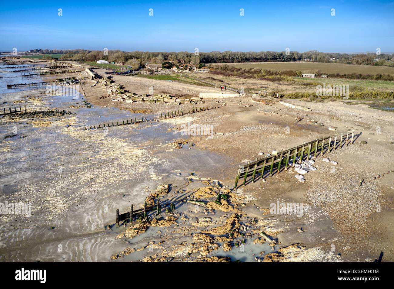 Wooden groynes and sea defences on a beach in Southern England after ...