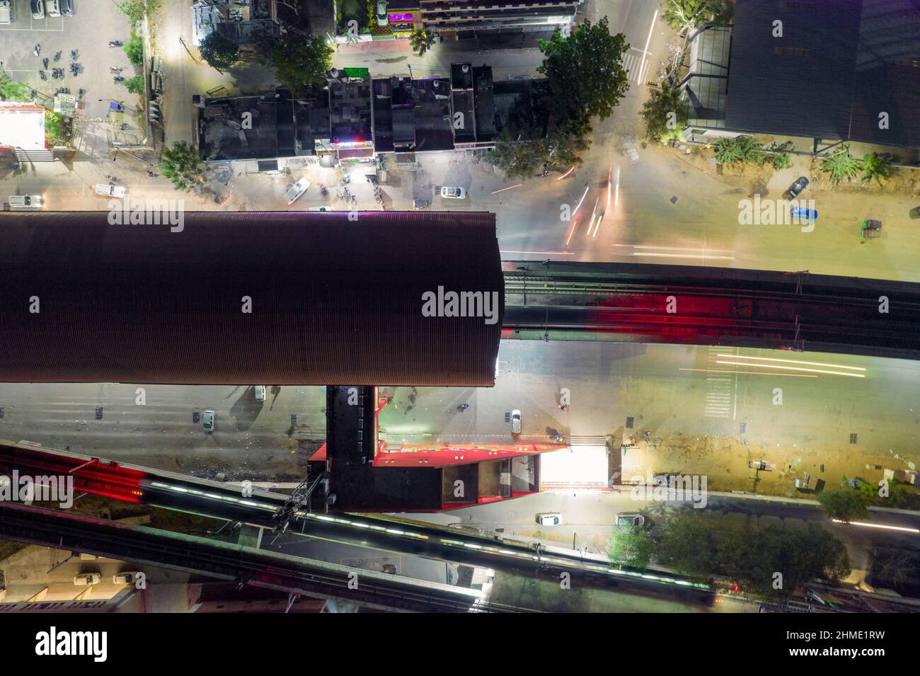top down flat aerial shot showing red roof of elevated metro train ...