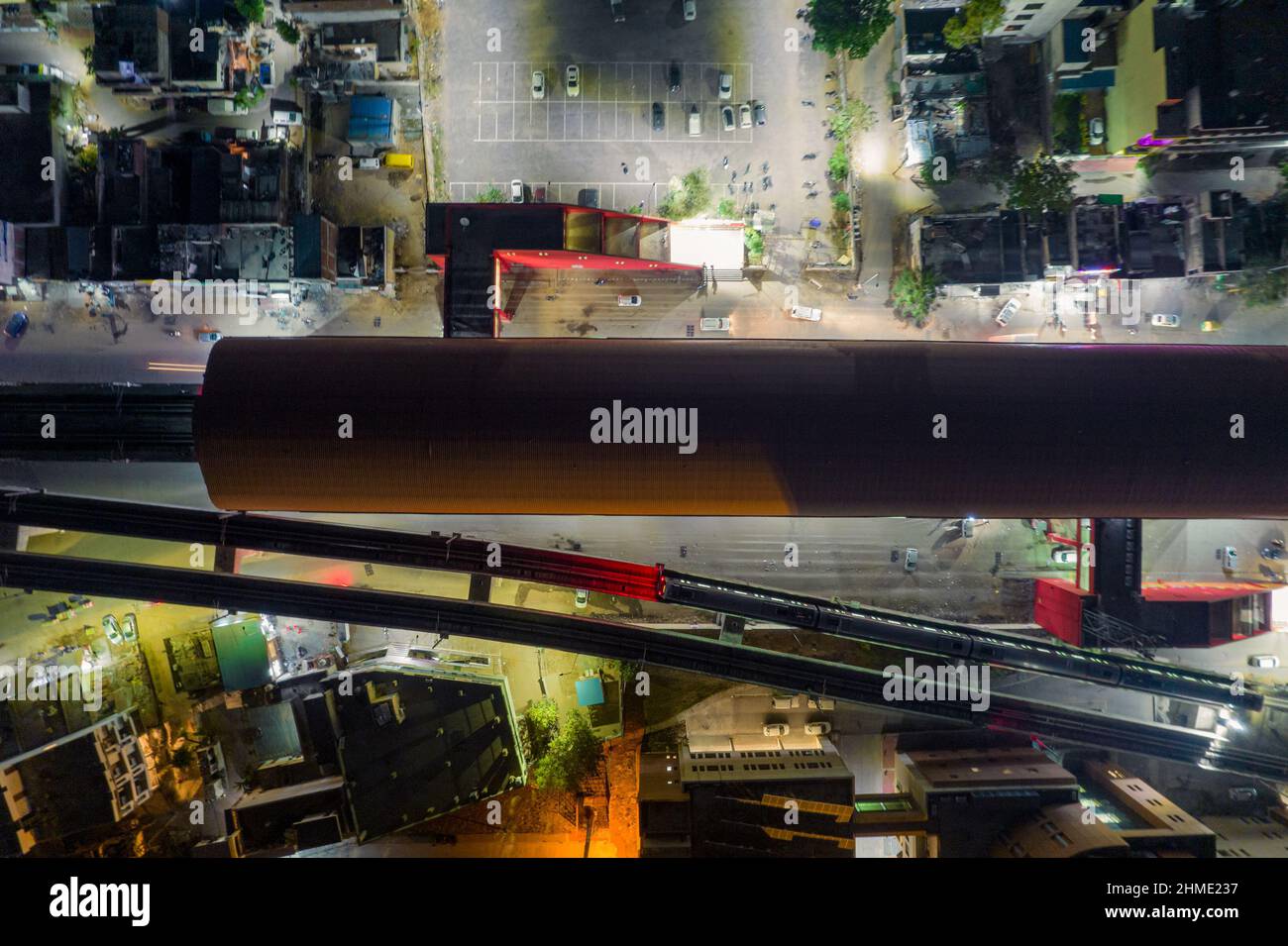 top down flat aerial shot showing red roof of elevated metro train ...