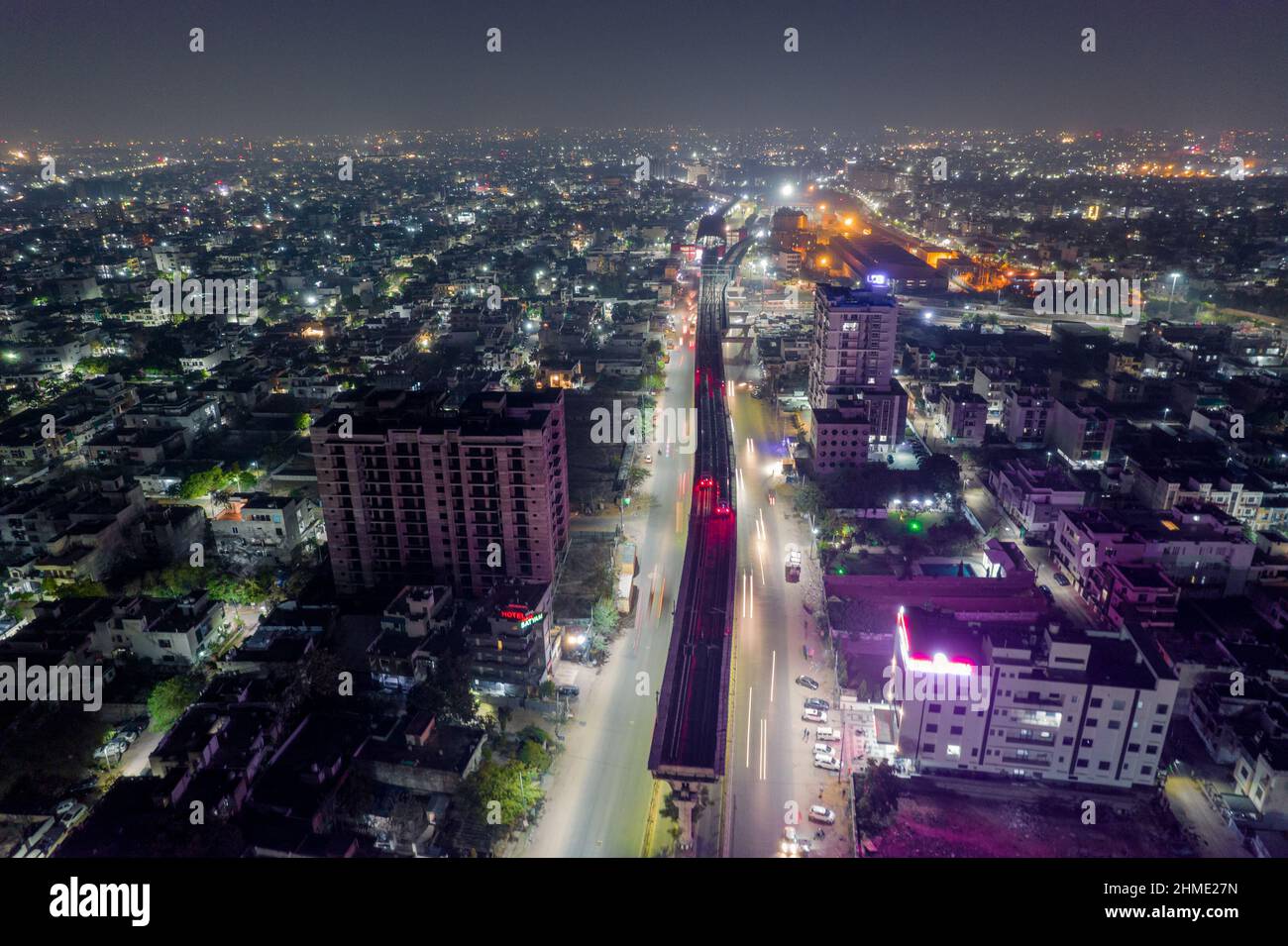 aerial drone shot with elevated metro train tracks over busy street ...