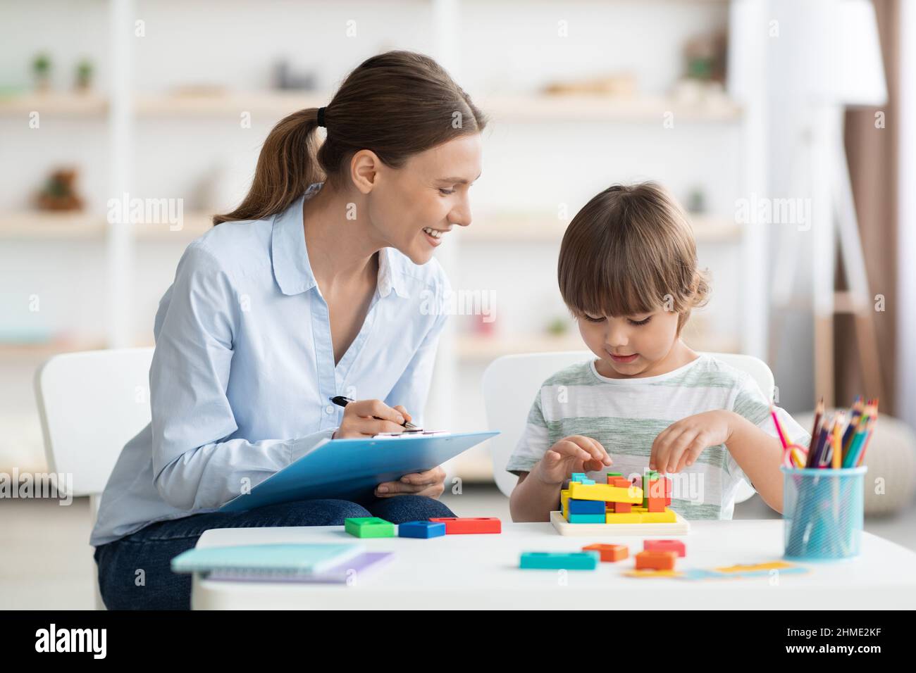 Early kids development. Cute little boy playing logical geometry game ...