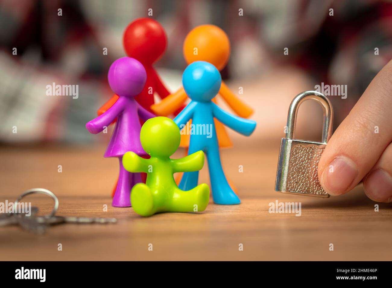 Family problems, plastic colorful figurines on wooden table with ...