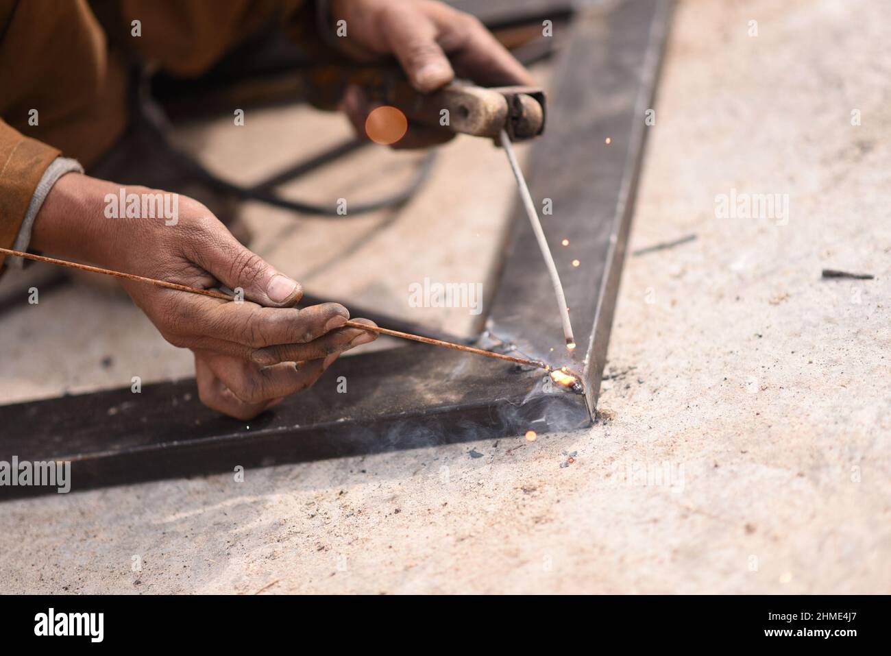 Steel welding, Welder works . Welding of the metal frame of the fence ...