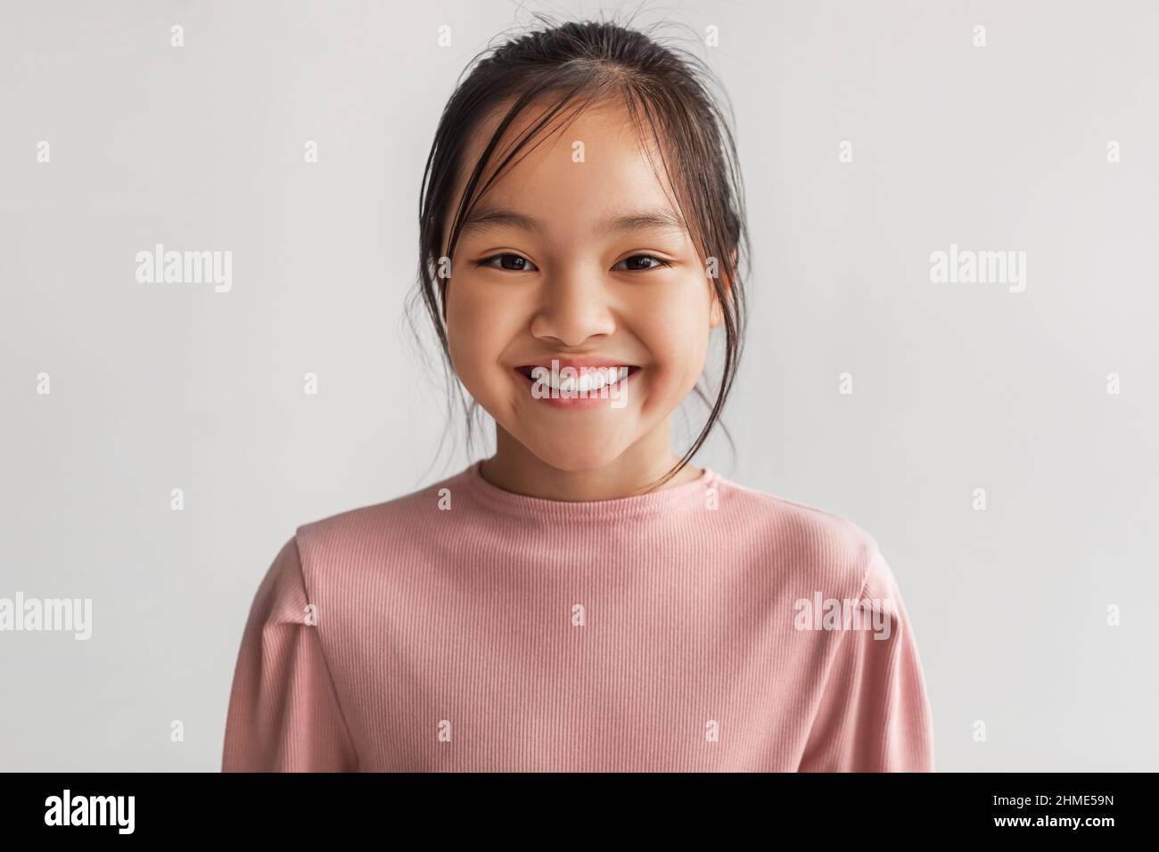Headshot Of Toothy Chinese Kid Girl Posing Smiling, Gray Background ...