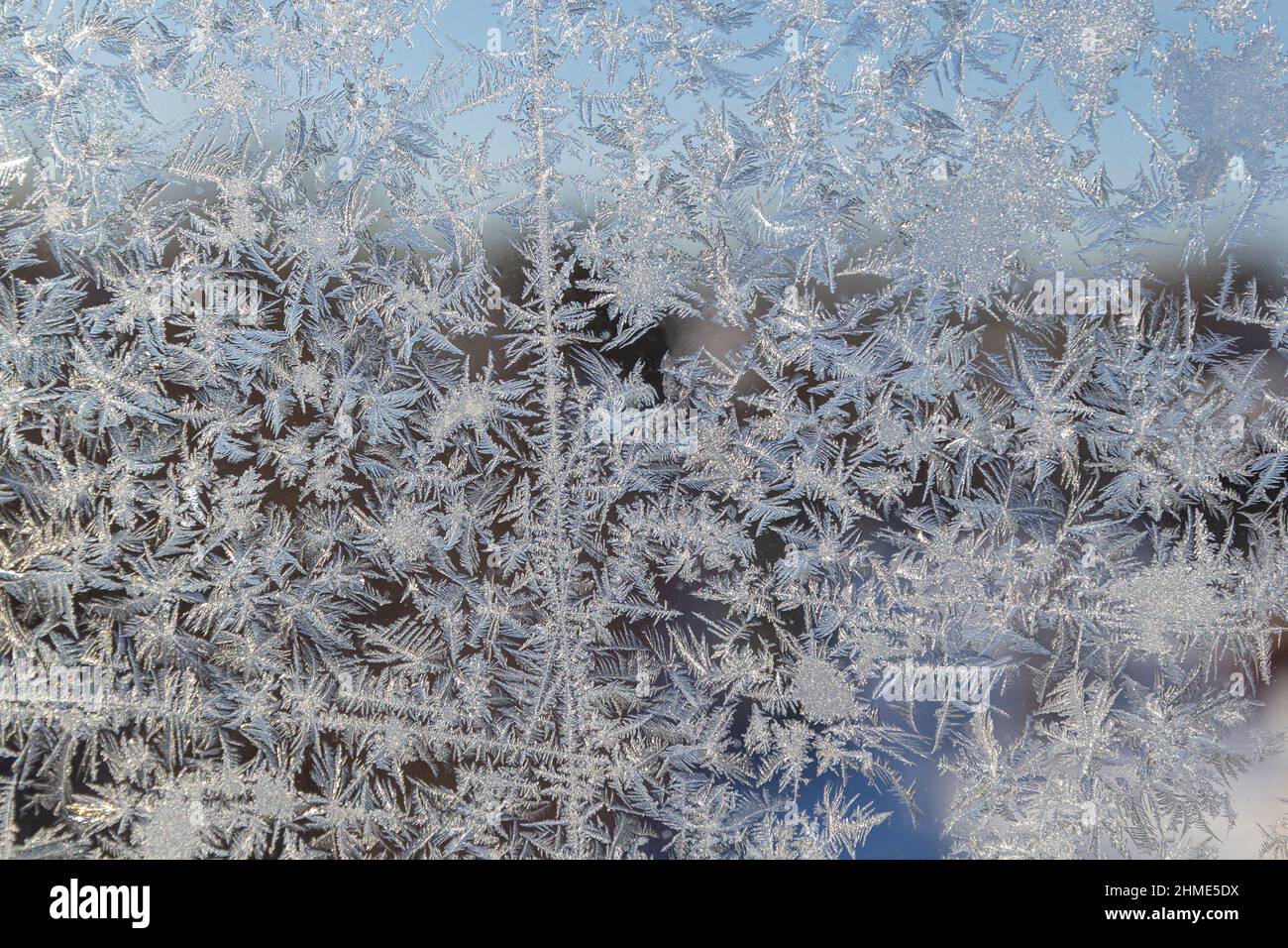 Melting ice running down a window pane, Closeup of frozen window pane ...