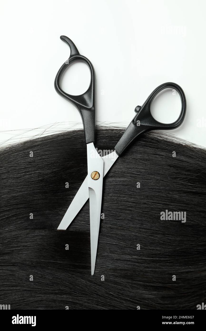 Female hair with scissors on white background Stock Photo - Alamy