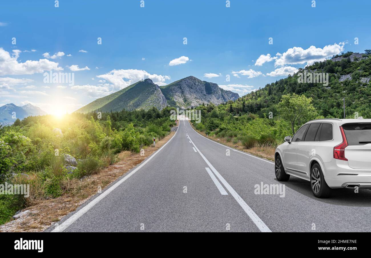 Car is driving along the road. White car on a suburban highway Stock ...