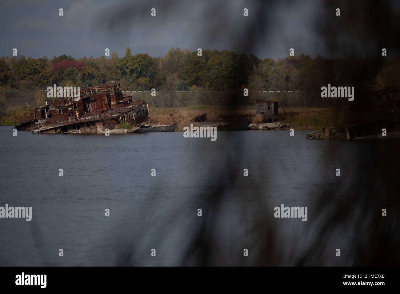 Sunken boats lie in the Chernobyl Ship Yard on the Pripyat River, near ...