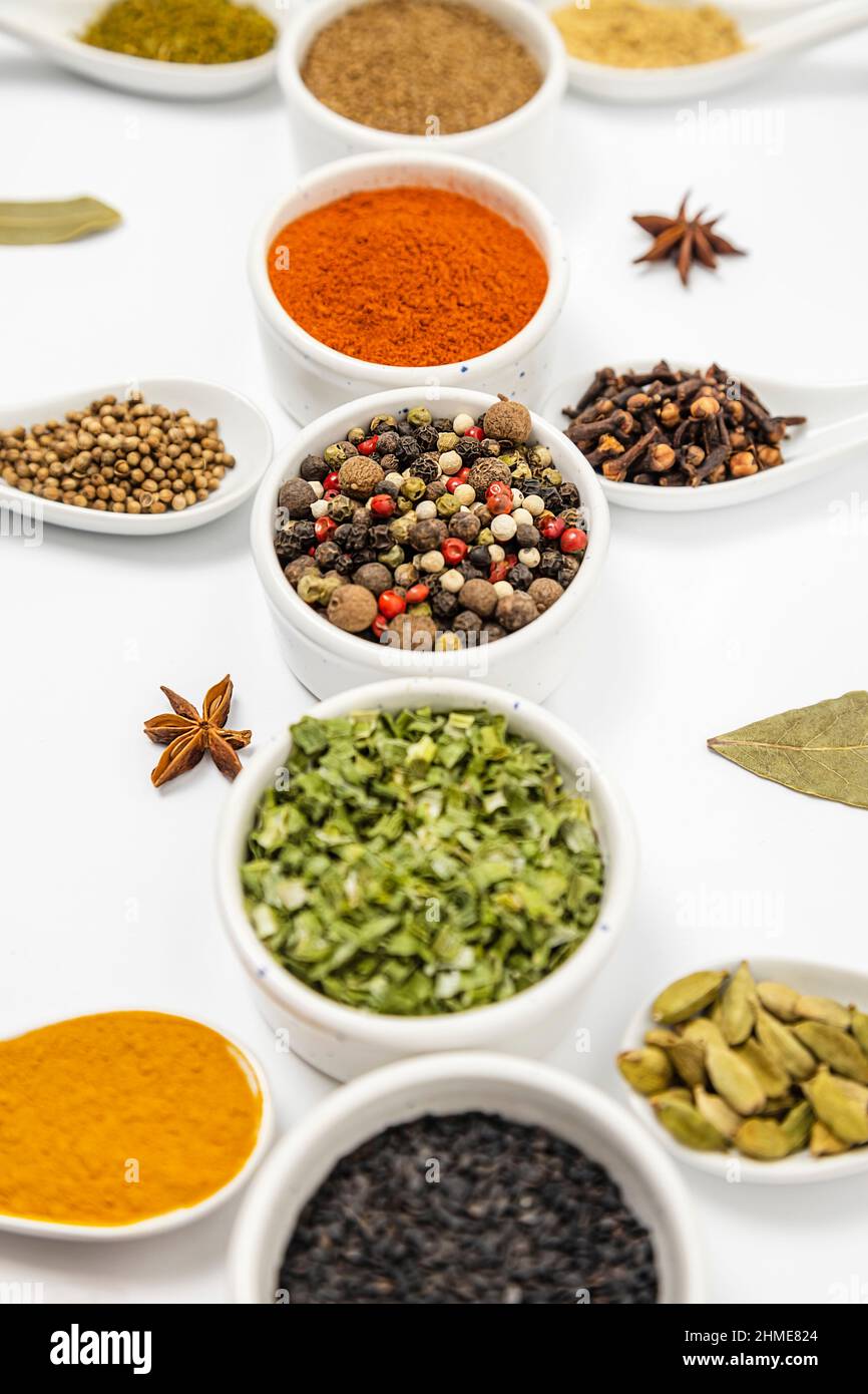 Multicolored condiments, different kinds of spices in ceramic bowls and ...