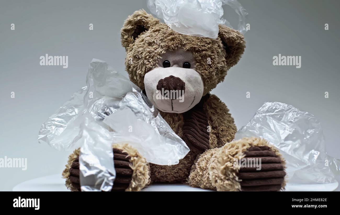 plastic bags falling on teddy bear isolated on grey Stock Photo - Alamy