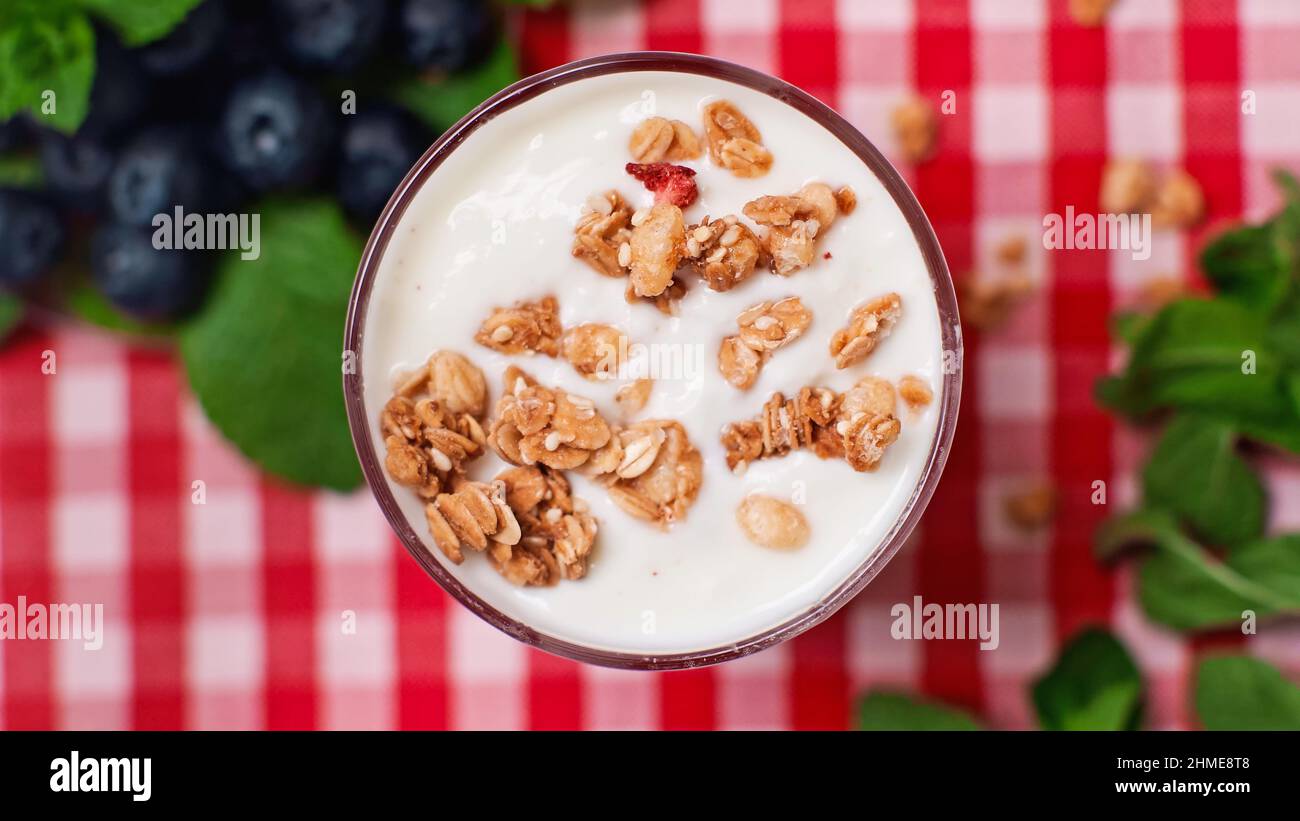 top view of crunchy granola on top of fresh yogurt in glass Stock Photo ...