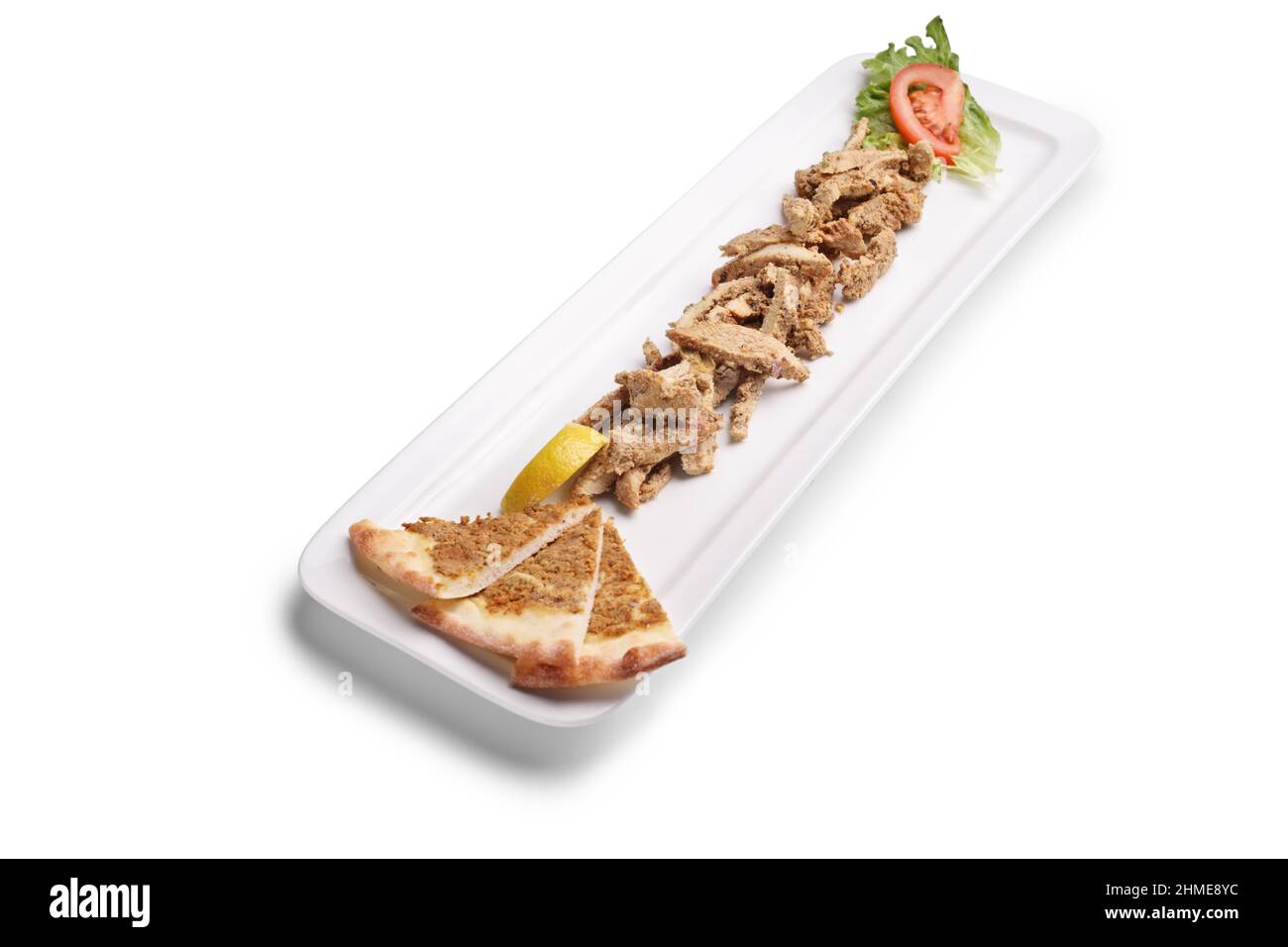 Arabic dish chicken shawarma and slices of lahmacun on a plate isolated ...