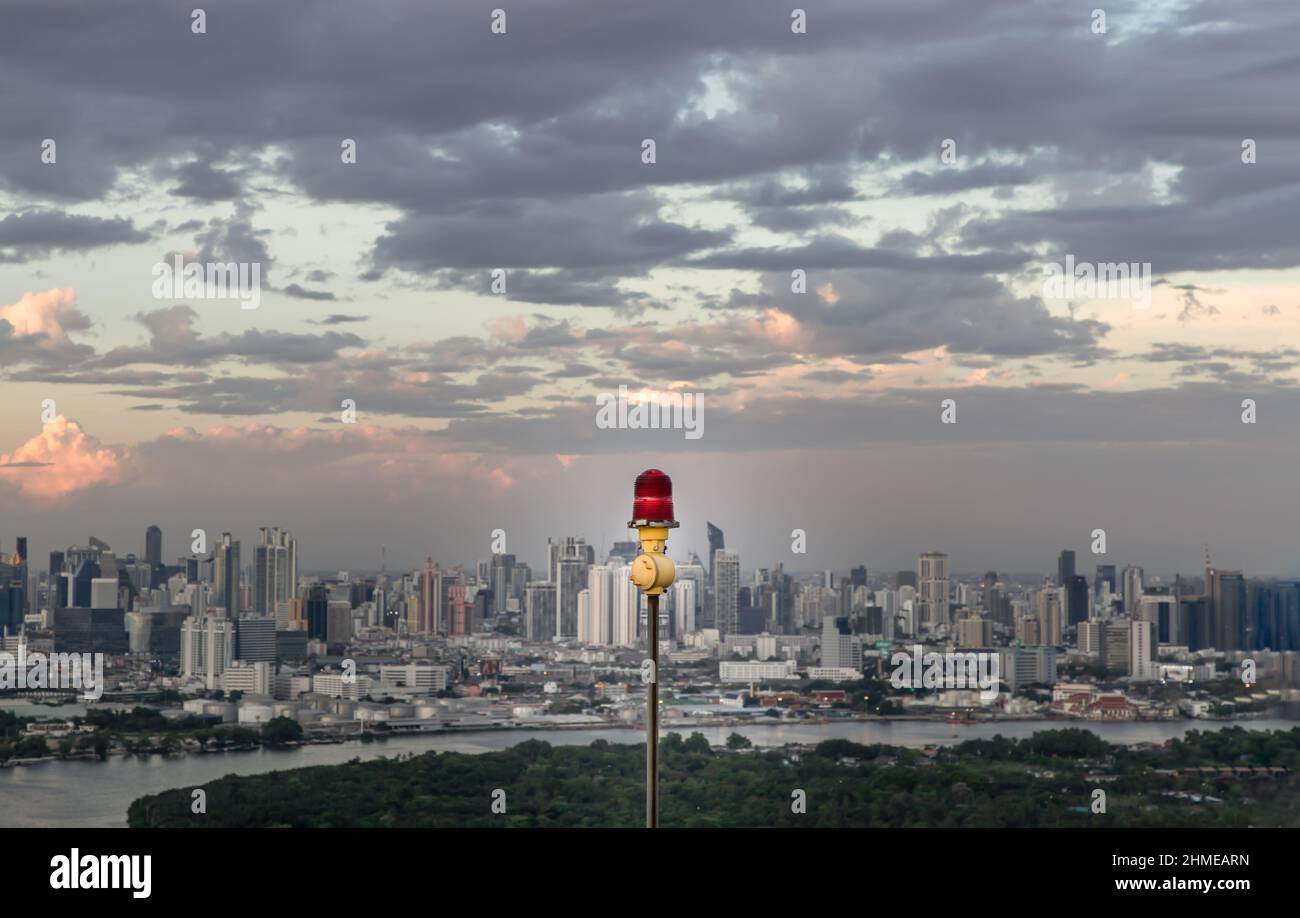 Red lantern of obstruction lights mounted on the rooftop of high rise ...