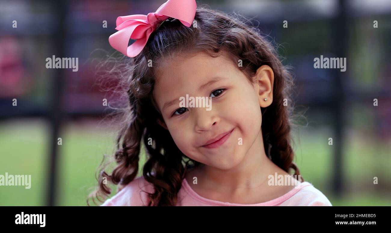 Charming diverse little girl child close-up face portrait smiling ...