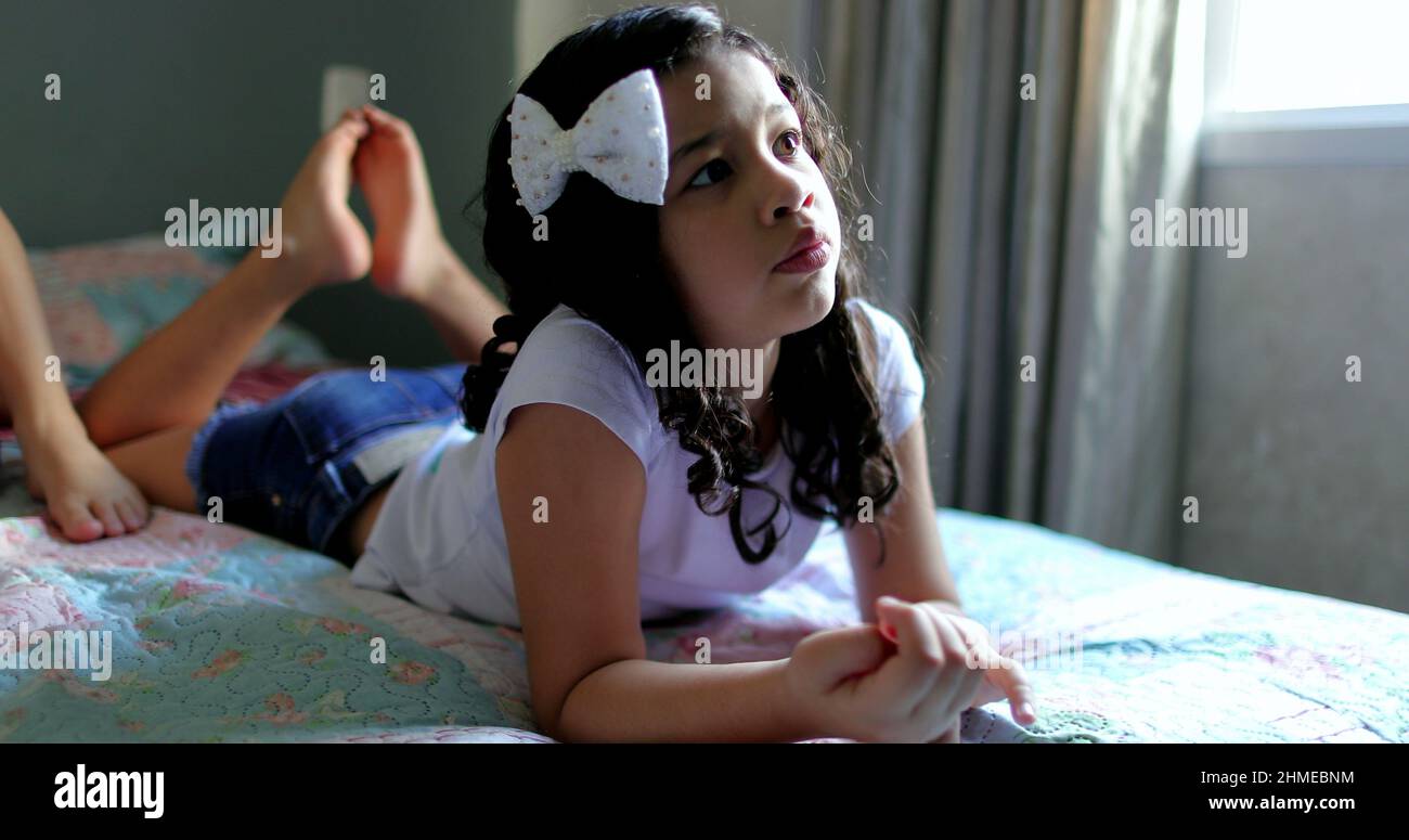 Children lied in bed watching cartoon Stock Photo - Alamy