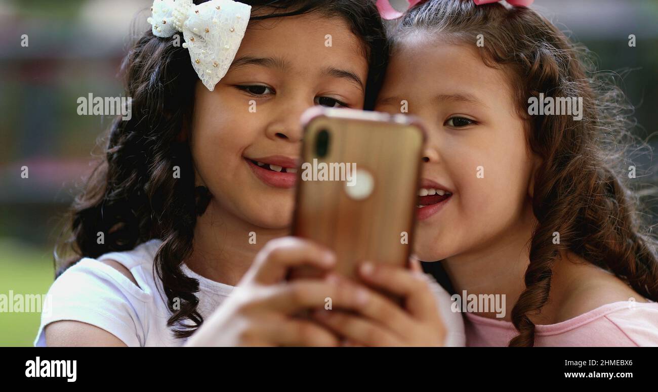 Children looking at cellphone device Stock Photo - Alamy