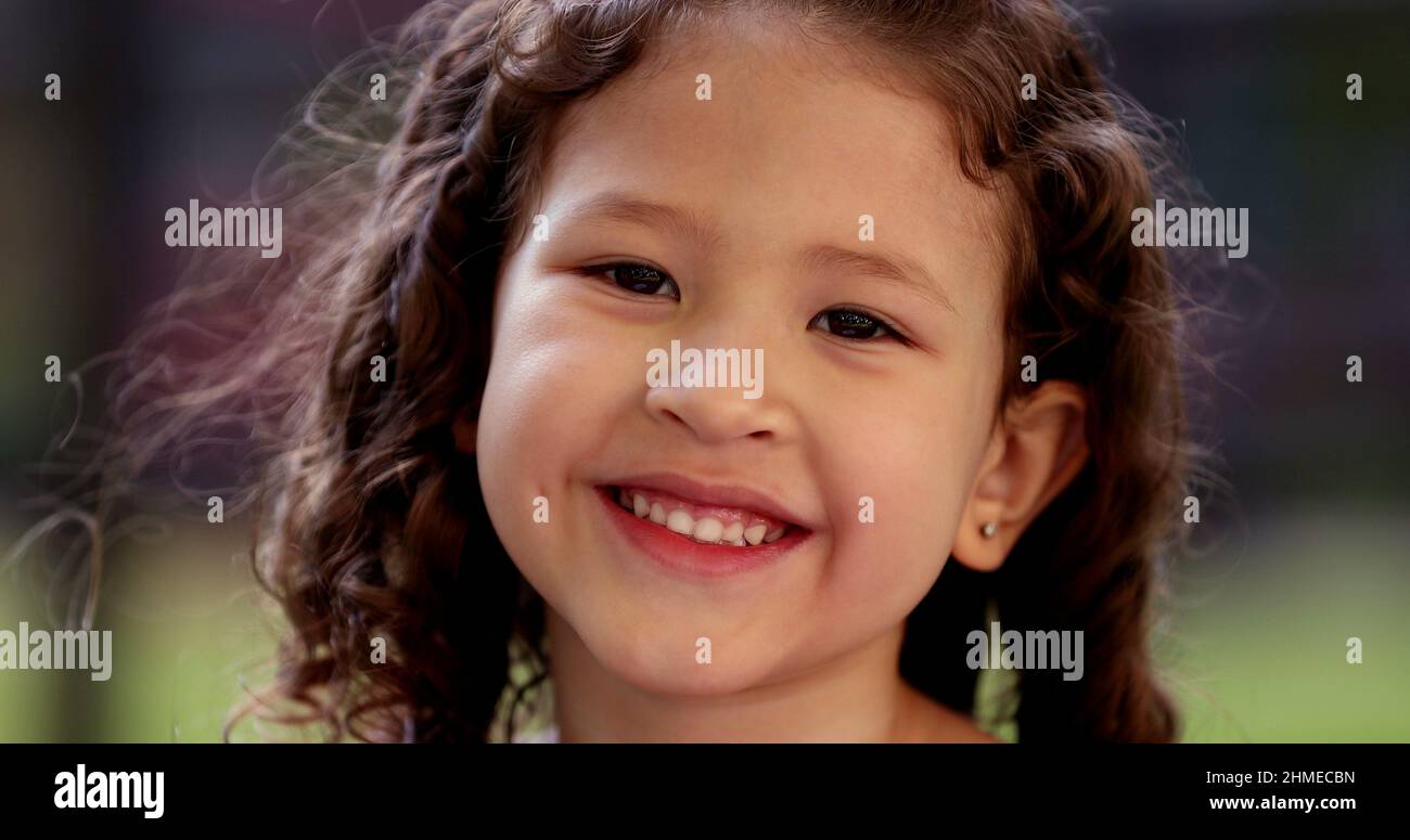 Happy little girl child smiling to camera with joy Stock Photo - Alamy