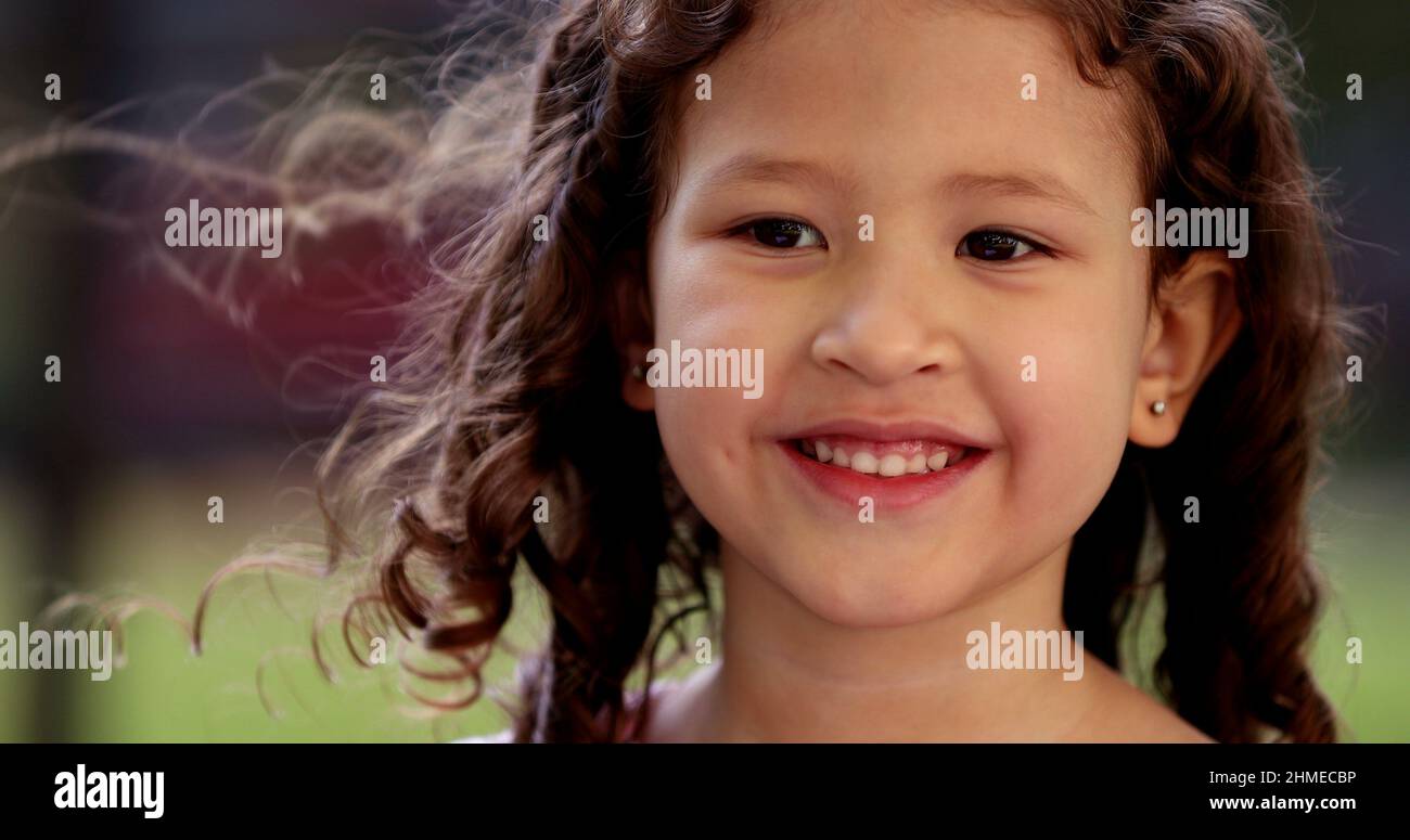 Happy little girl child smiling to camera with joy Stock Photo - Alamy