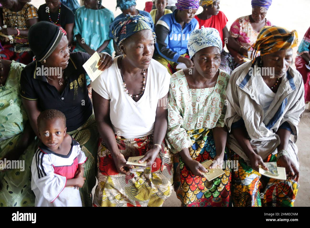 People gather at a community bank in Sierra Leone to deposit and save ...