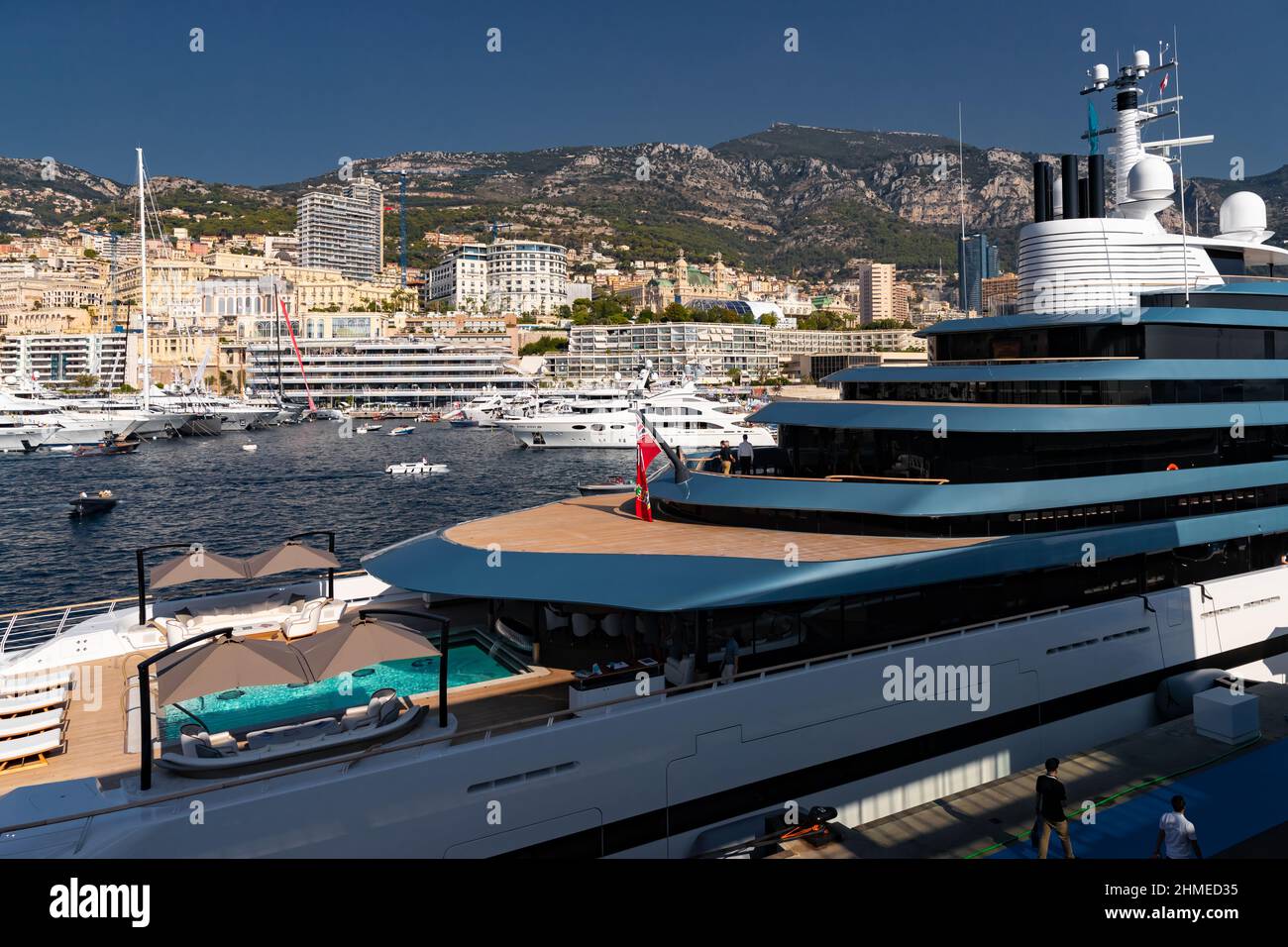 Landmarks of Monaco through decks of huge yacht of blue color in port ...