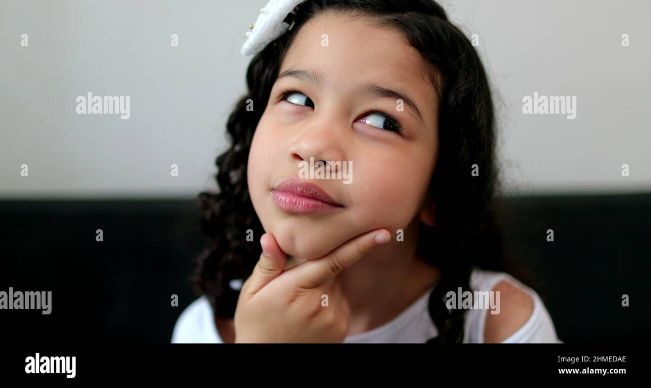 Thoughtful little girl child thinking, pensive kid Stock Photo - Alamy
