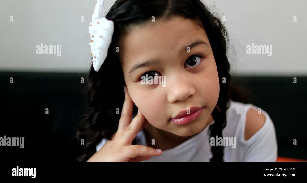 Thoughtful little girl child thinking, pensive kid Stock Photo - Alamy