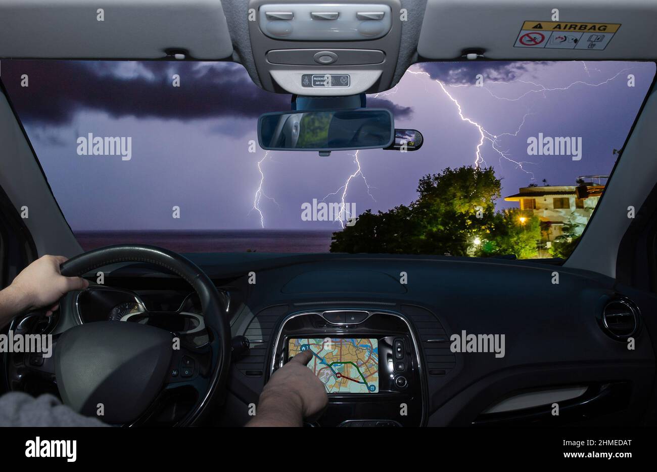 Driving a car while using the touch screen of a GPS navigation system ...