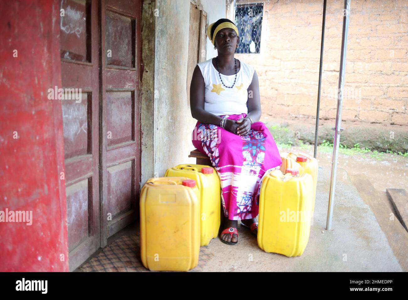 A woman outside her home in a rural area of Sierra Leone, west Africa ...