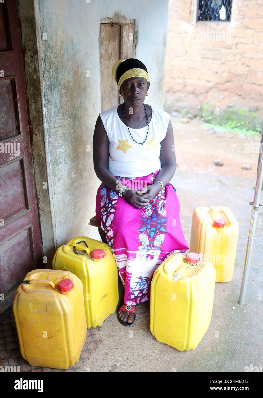 A woman outside her home in a rural area of Sierra Leone, west Africa ...