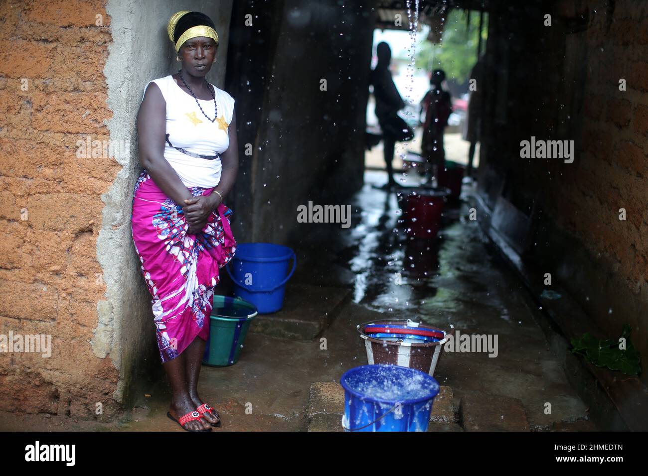 A woman outside her home in a rural area of Sierra Leone, west Africa ...