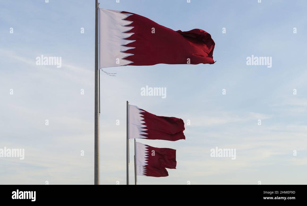 many qatar flags flying high in the wind Stock Photo - Alamy