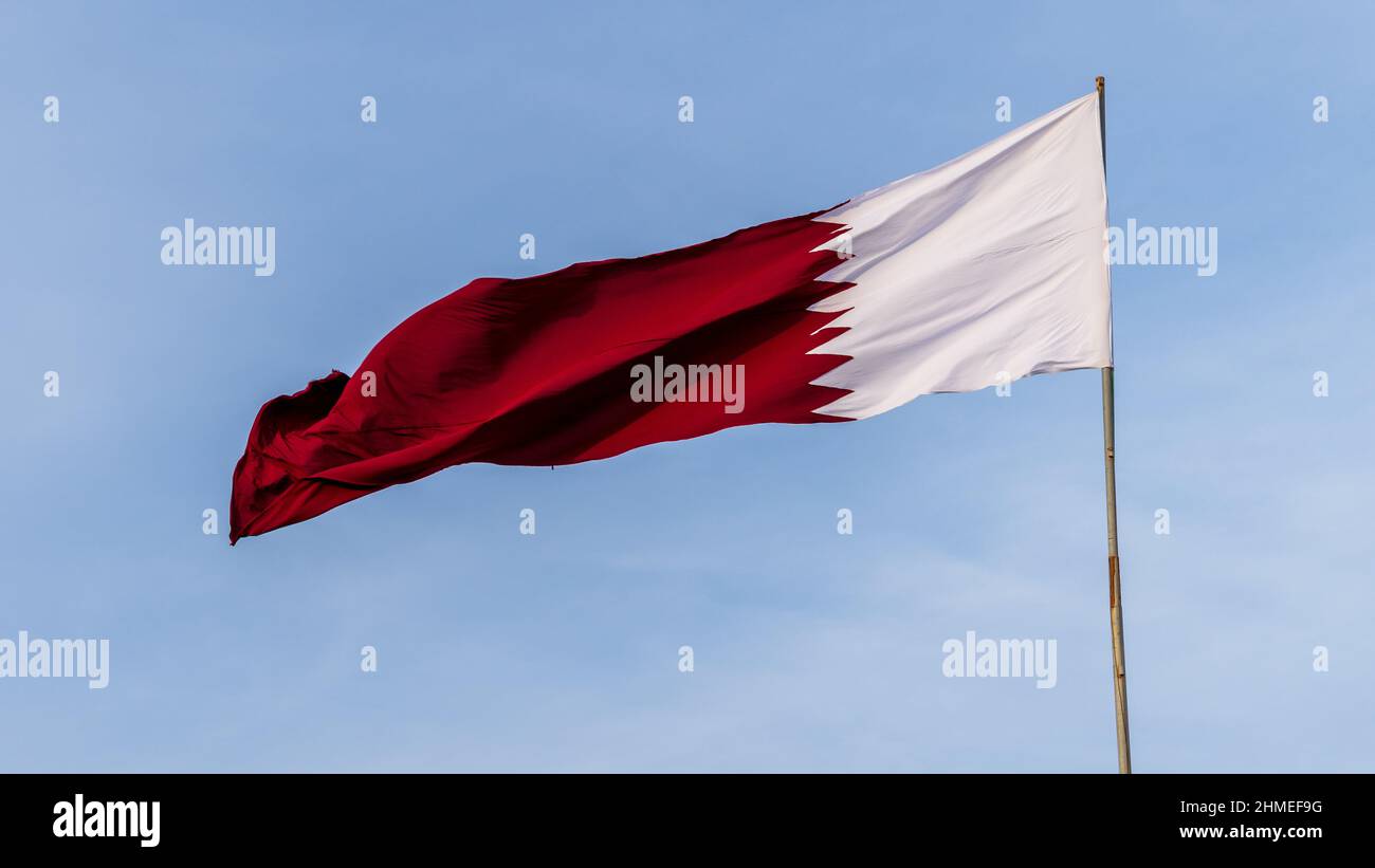 qatar flag flying high in the wind.tied to a bamboo stick Stock Photo ...
