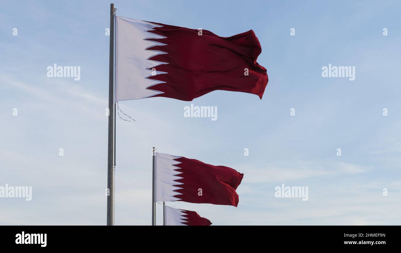 many qatar flags flying high in the wind Stock Photo - Alamy