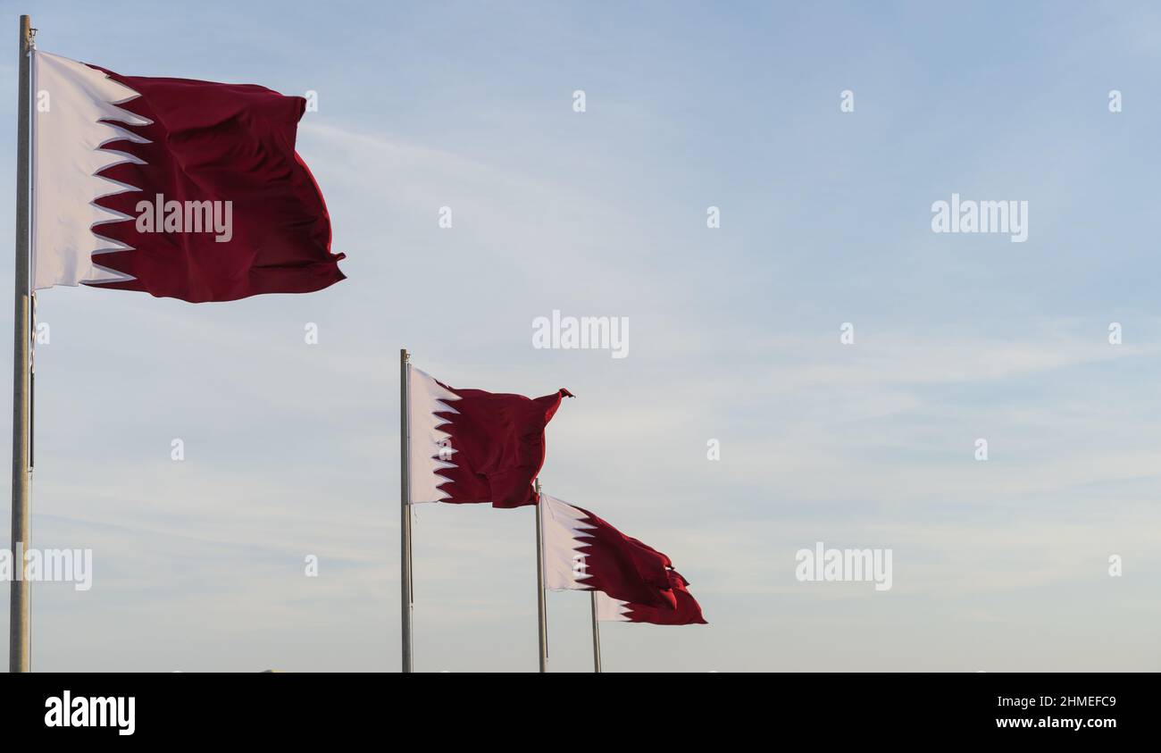 many qatar flags flying high in the wind Stock Photo - Alamy