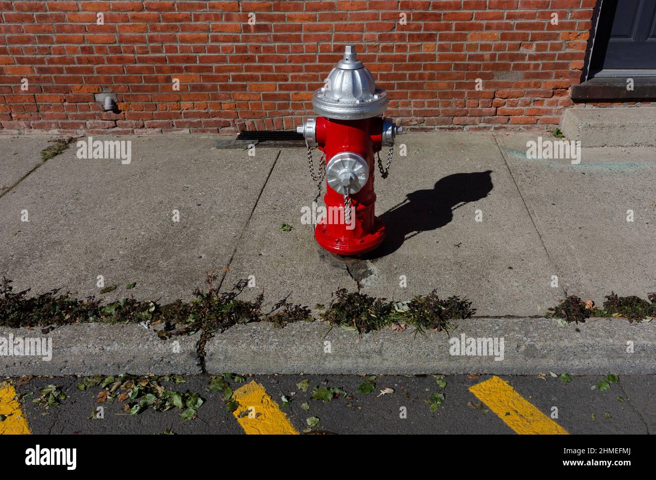 Red fire hydrant on a sidewalk Stock Photo - Alamy
