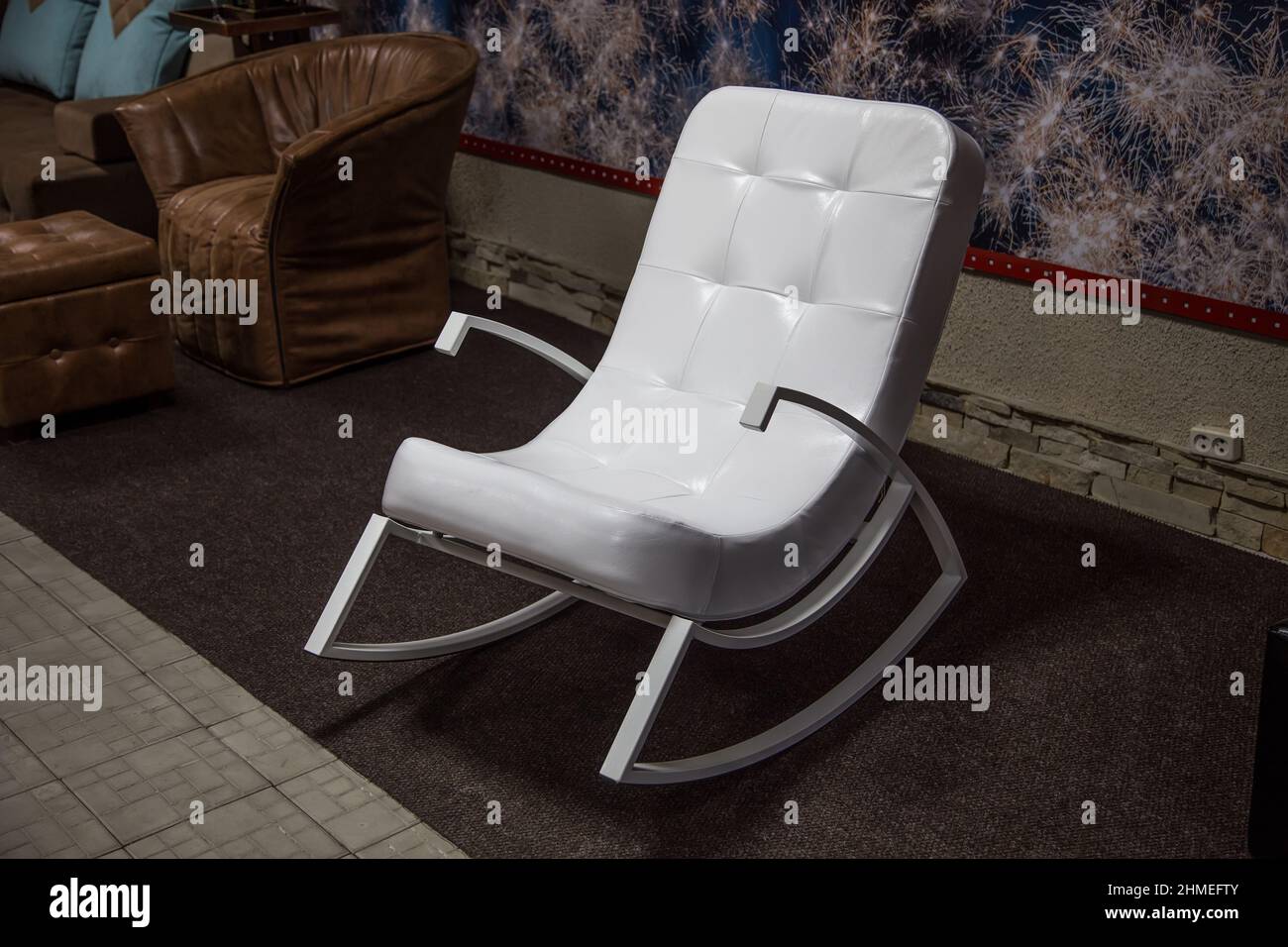 Modern white leather rocking chair staying in showroom Stock Photo - Alamy