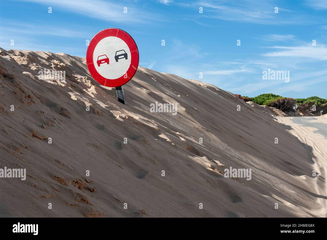 Traffic sign buried by the sand dunes Stock Photo - Alamy