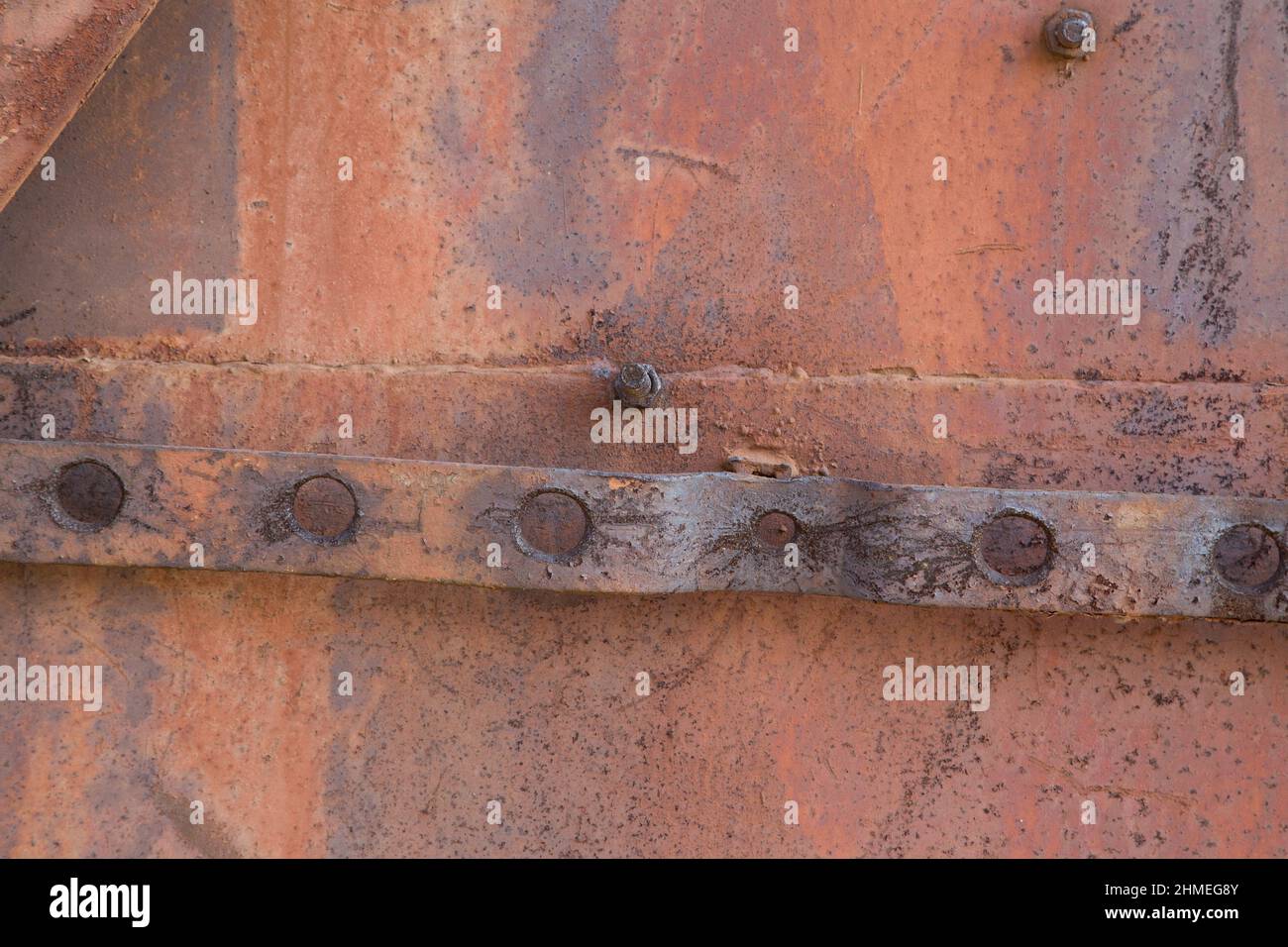 Old rusty metal plate with holes and bolts Stock Photo - Alamy