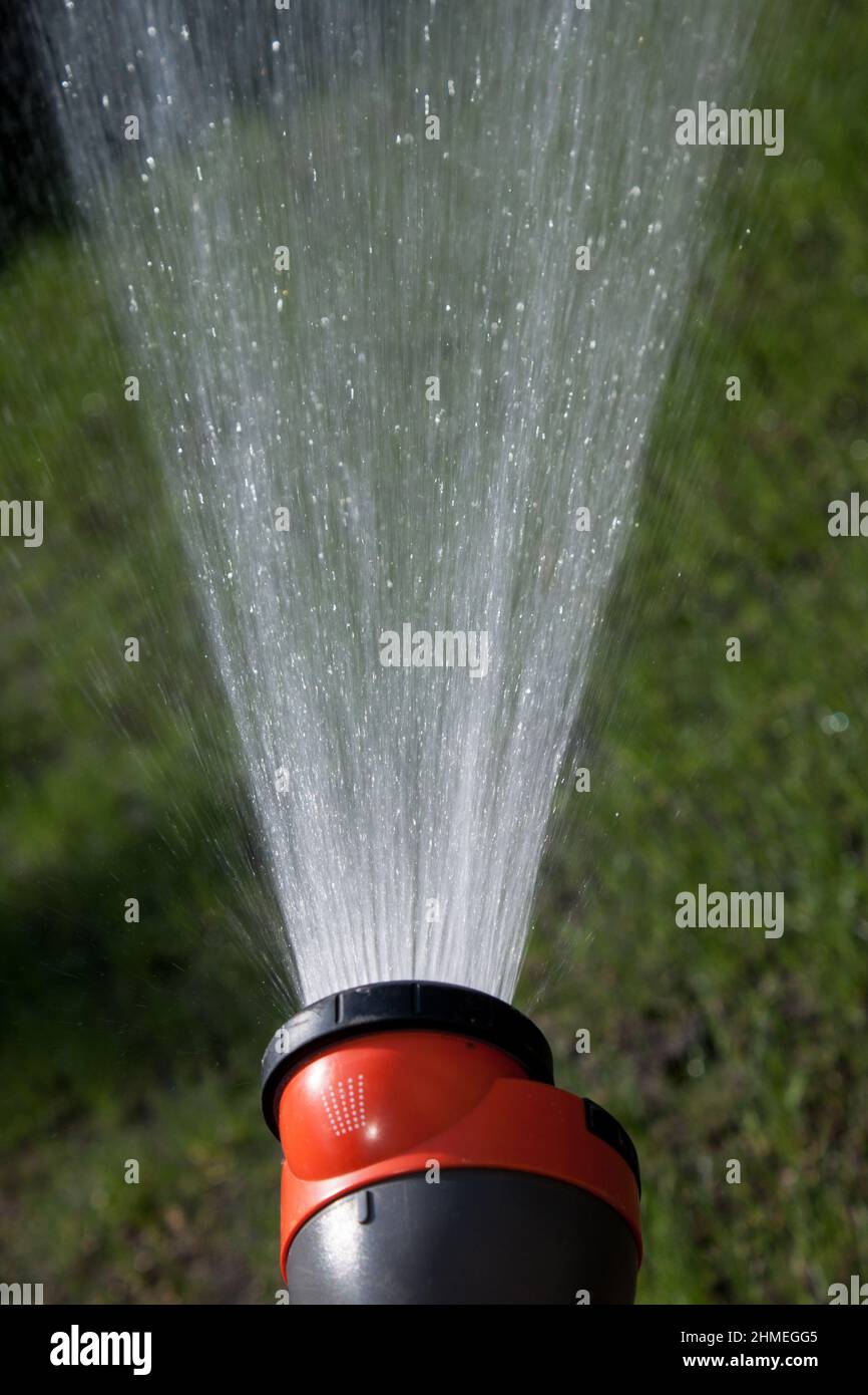 Water flying out of the hose. Vertical image Stock Photo - Alamy