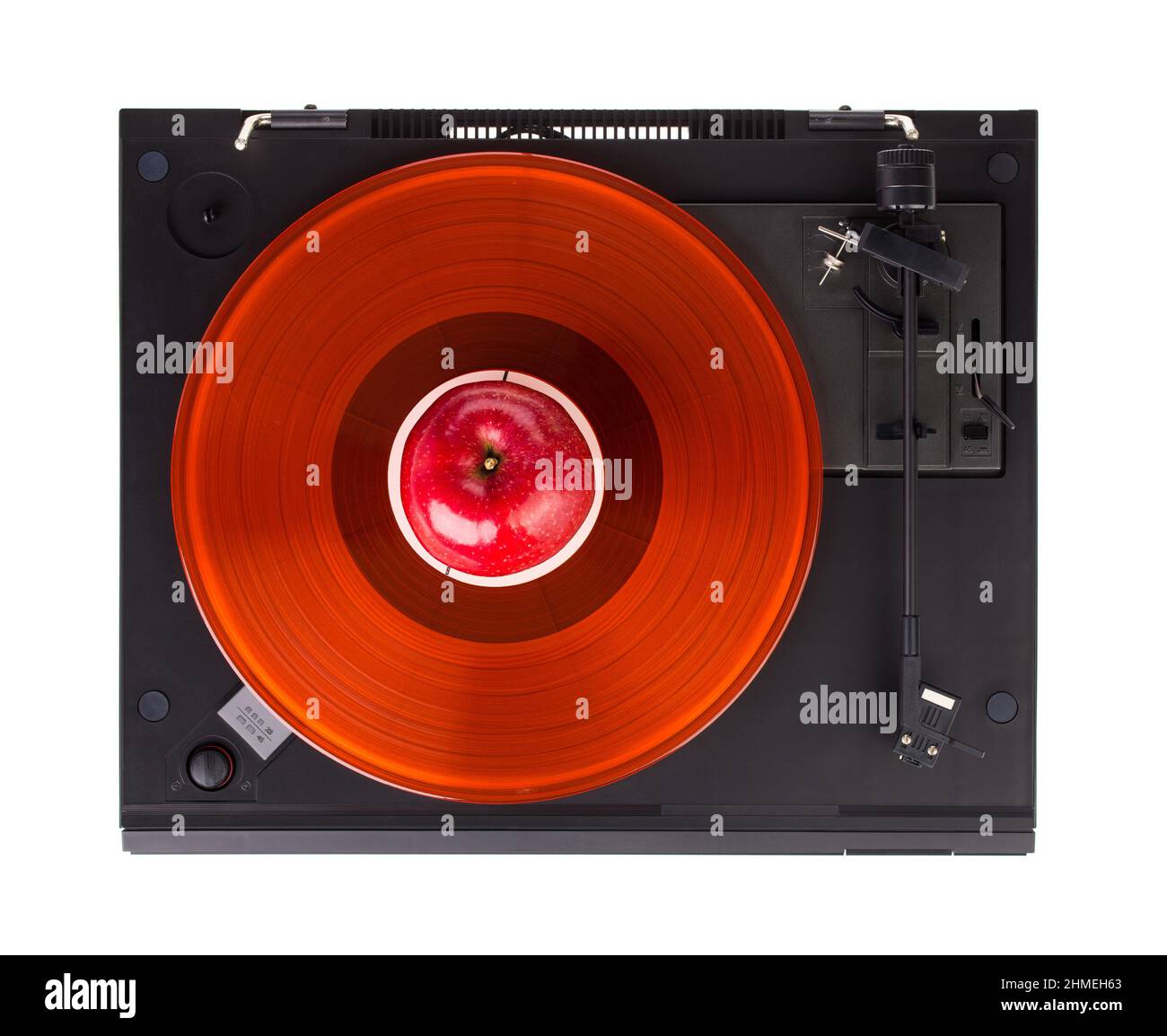 old fashioned turntable playing a track from orange vinyl with an apple ...