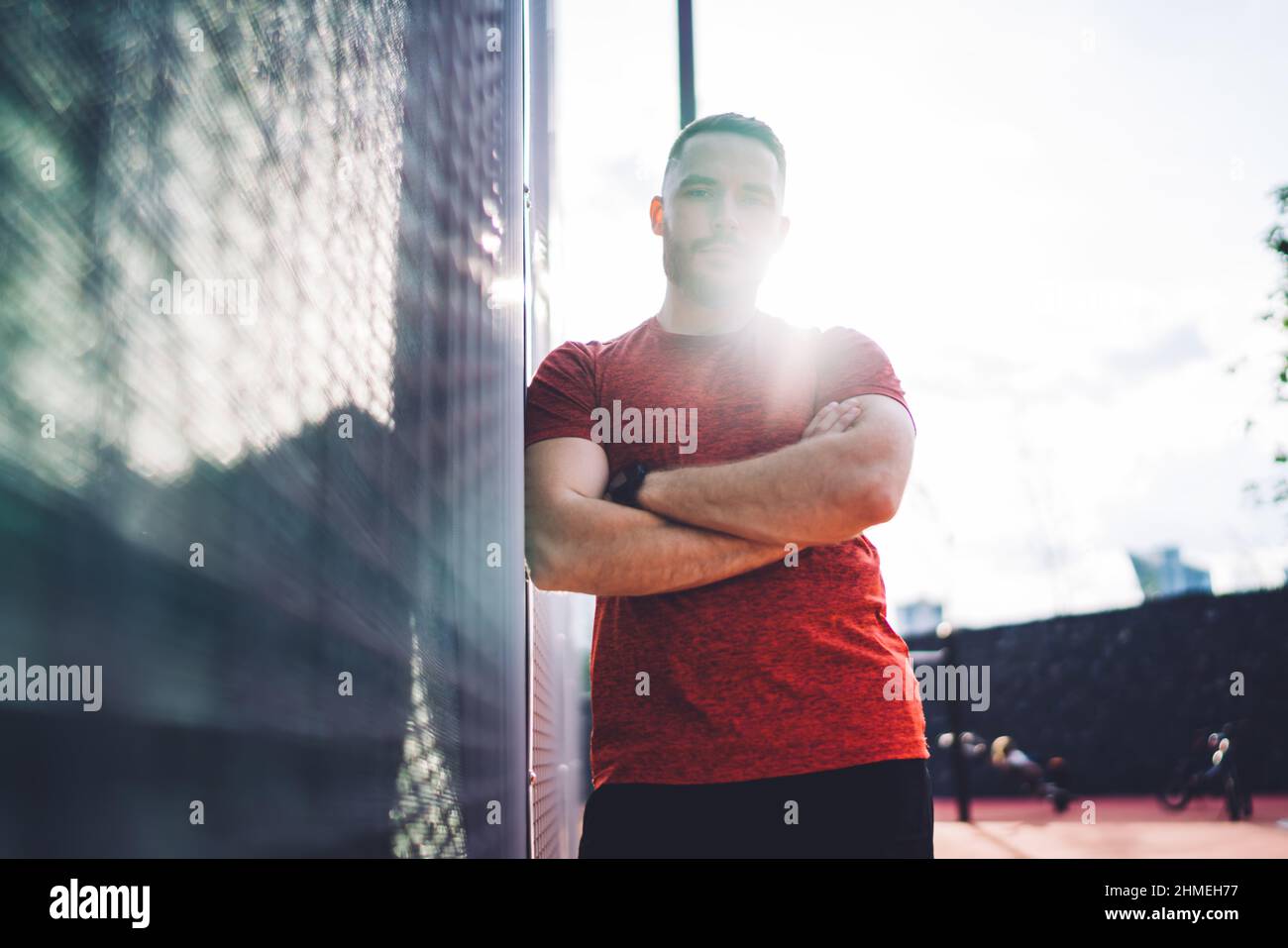 Young man standing against wall Stock Photo - Alamy
