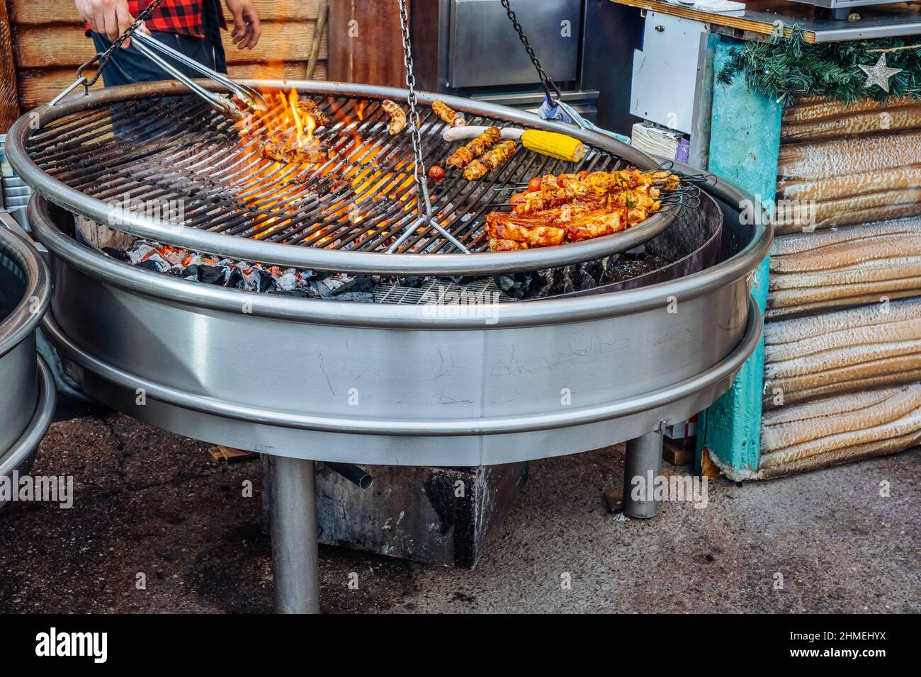 Assorted grilled meat on barbecue grill with smoke and flames of fire ...