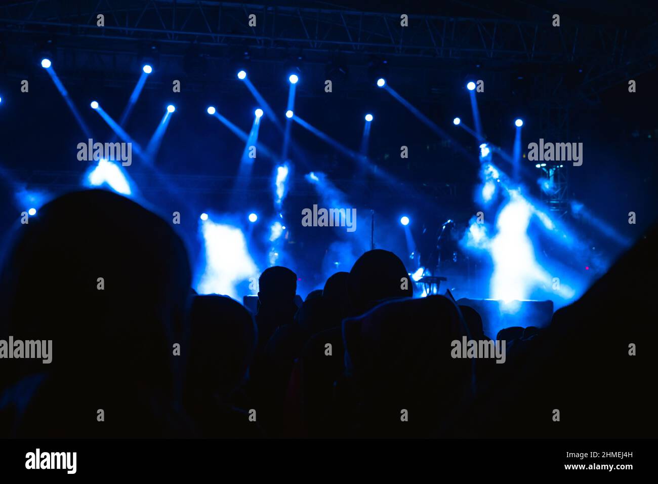 Concert. Spotlights on the stage with fog effect. Noise included ...